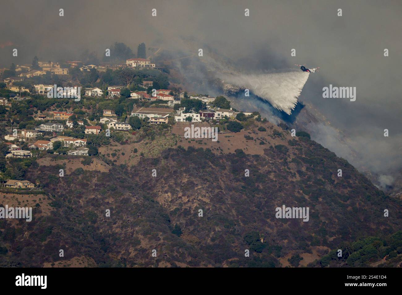 Firefighting assists from above as flames from the Palisades Fire burn ...