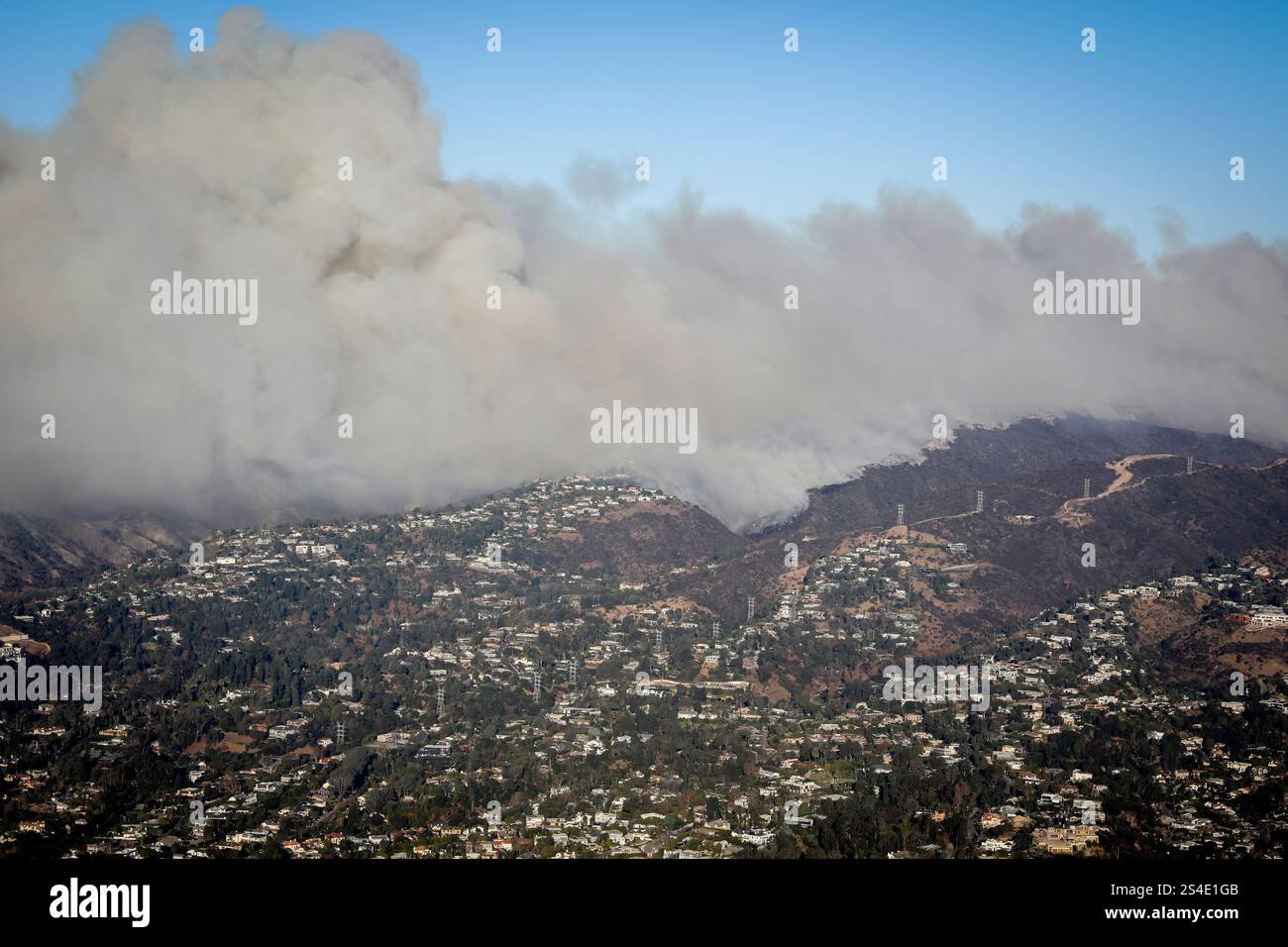 Flames from the Palisades Fire burn along the ridge line near ...