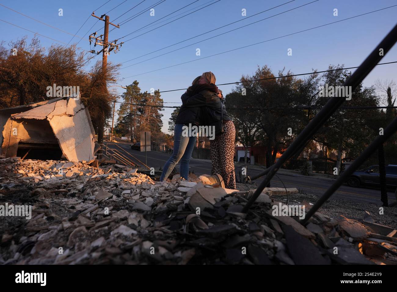 Alison Jernegan, left, hugs Brynna Venne after Brynna's home was ...