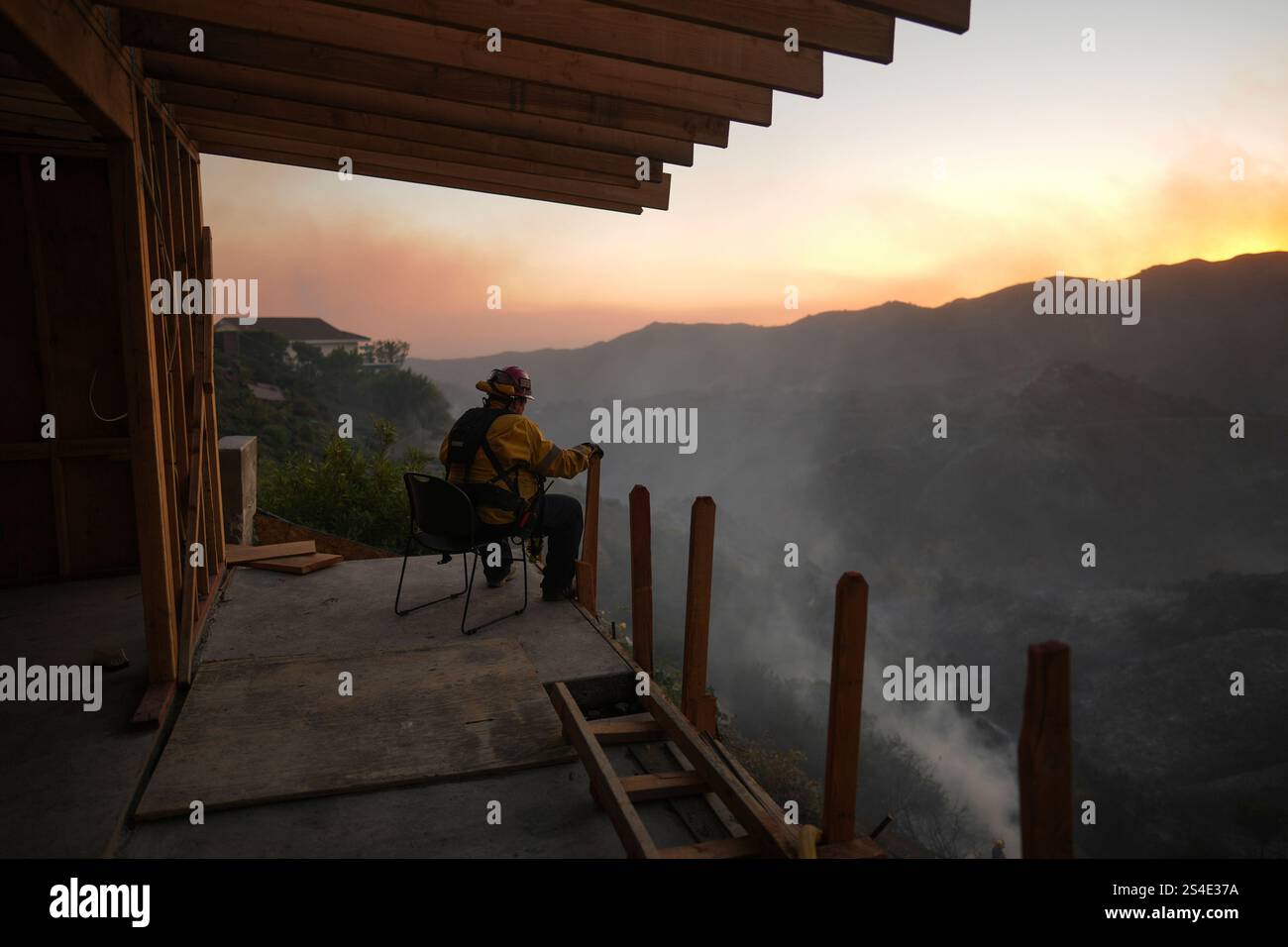 A firefighter rests as crews battle the Palisades Fire in Mandeville ...