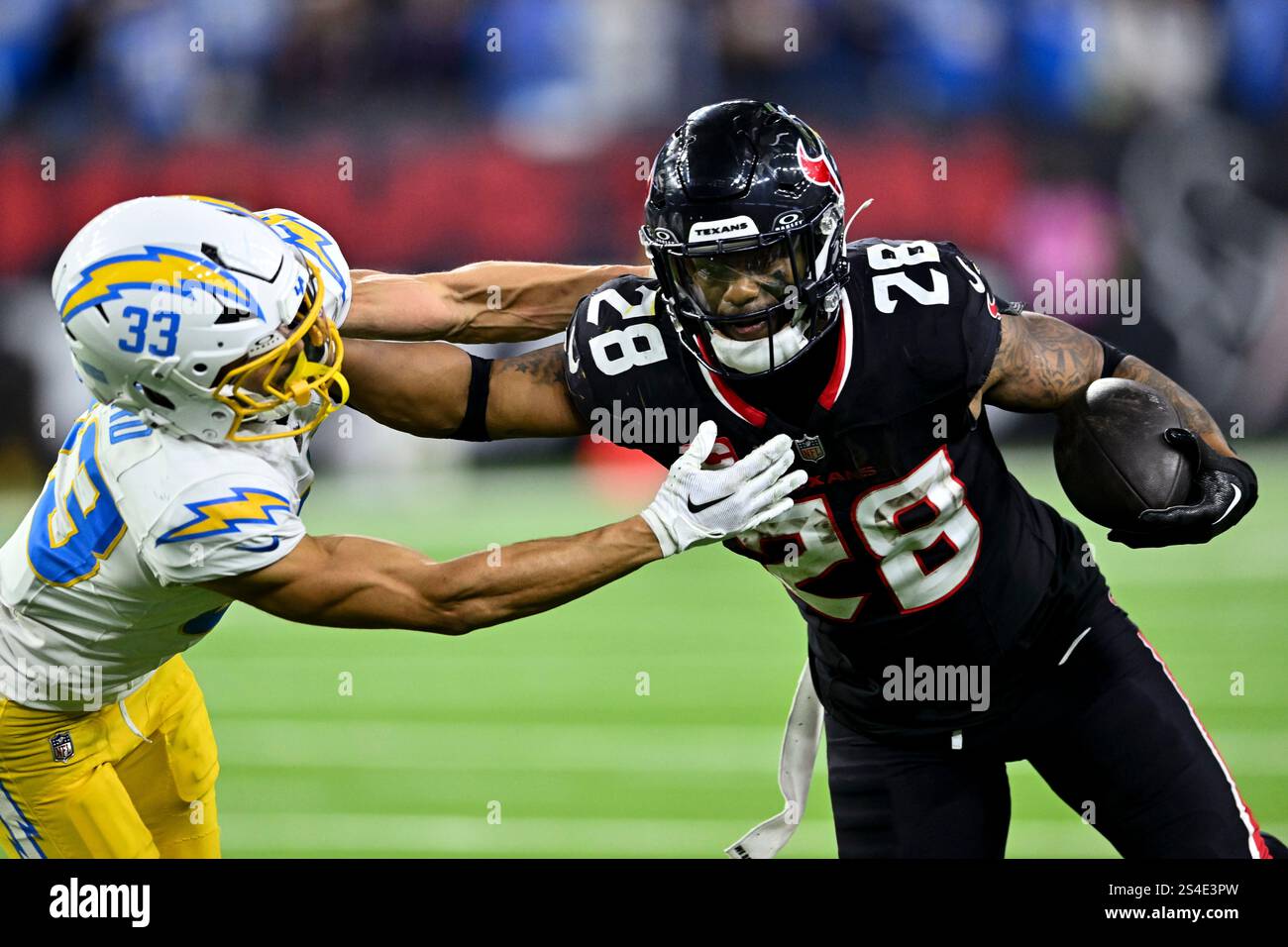 Houston Texans running back Joe Mixon (28) stiff arms Los Angeles ...