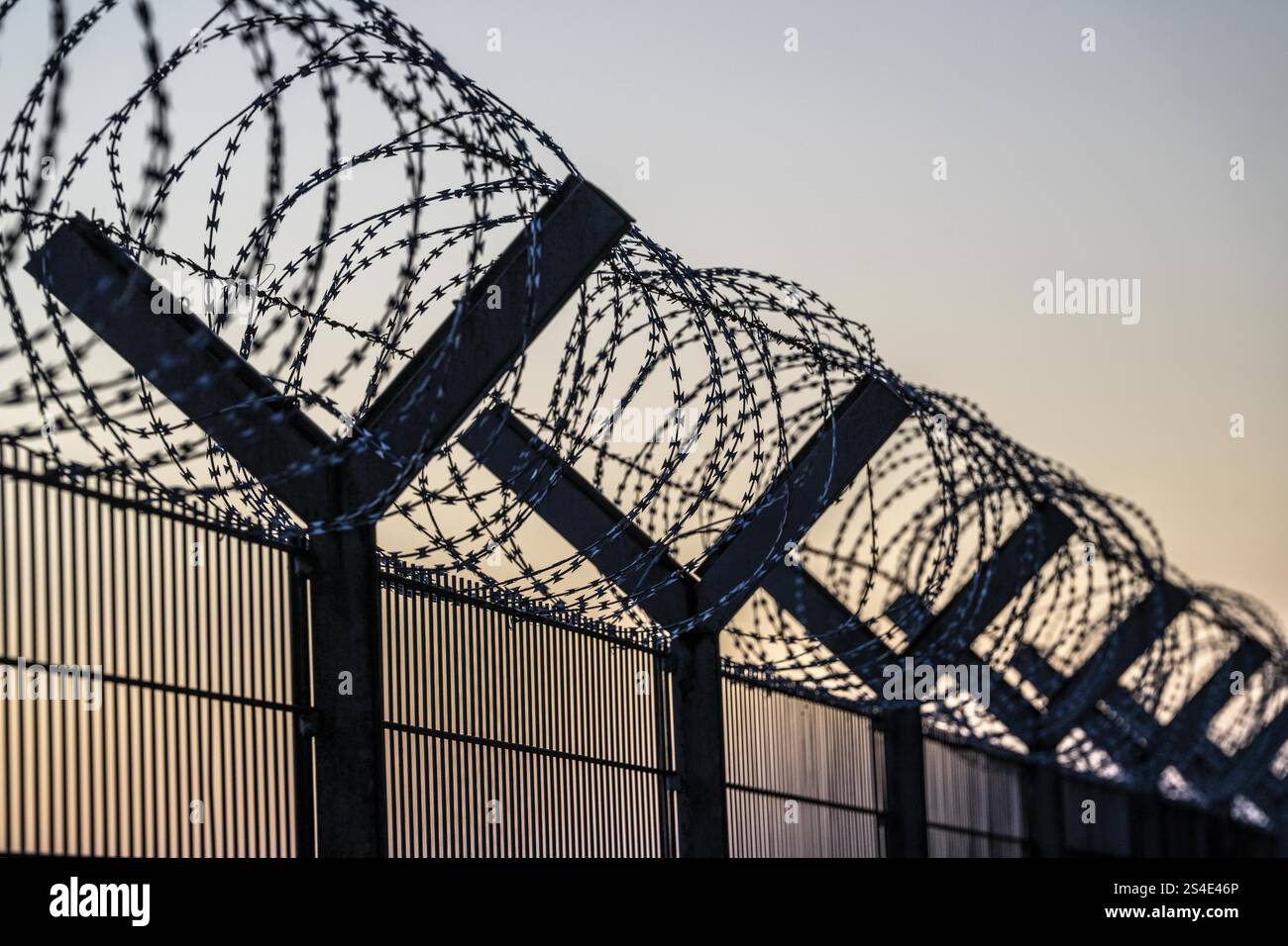 Symbolic image security, S-wire rolls, NATO wire, on a fence top ...