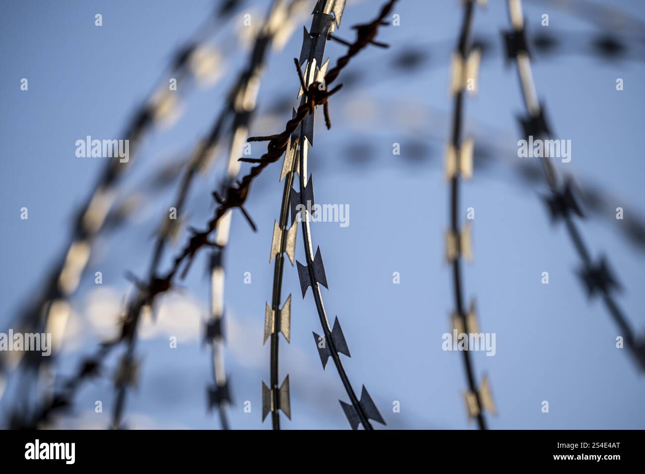 Symbolic image security, S-wire rolls, NATO wire, on a fence top ...