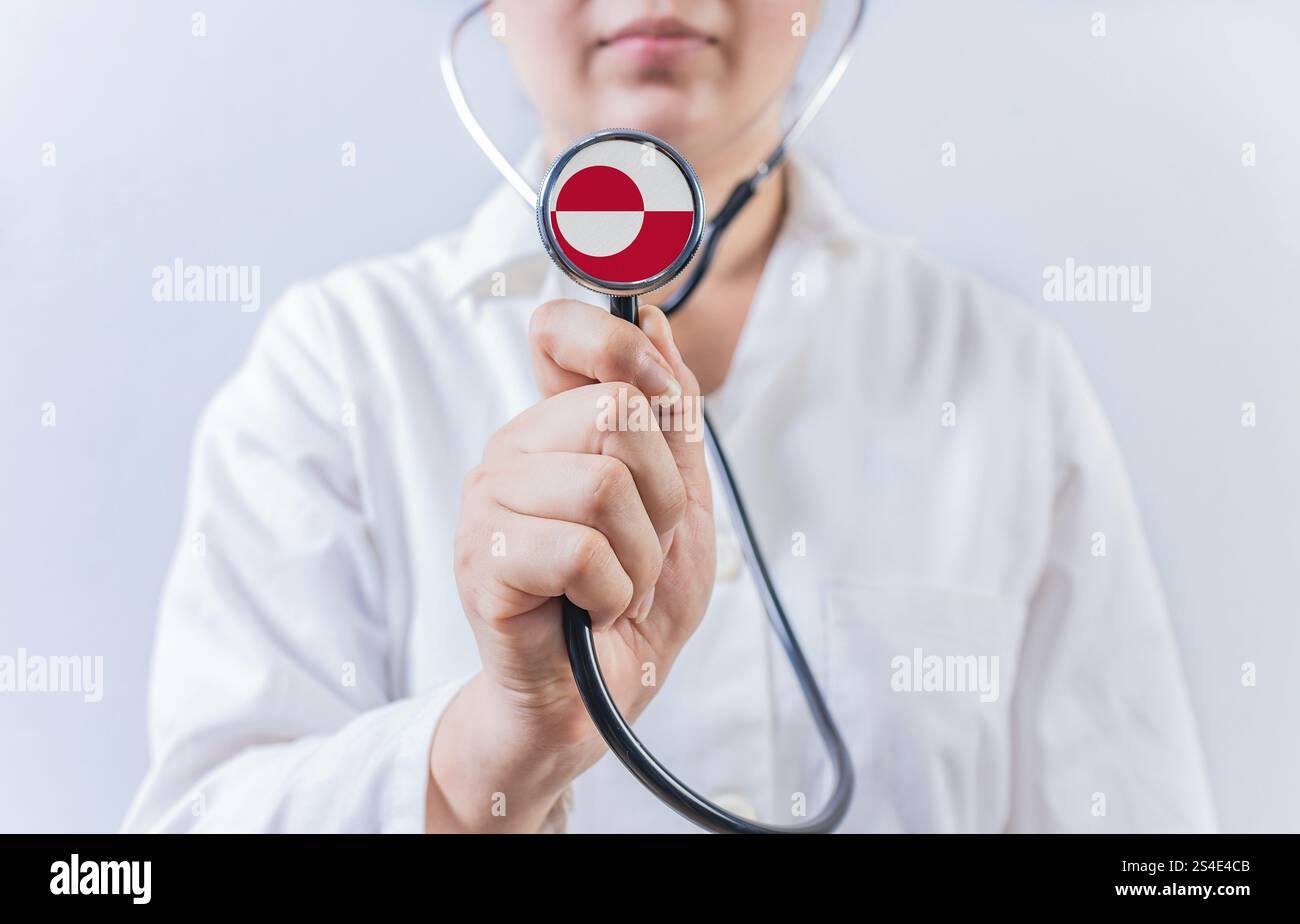 Female doctor holding stethoscope with Greenland flag. National Health ...