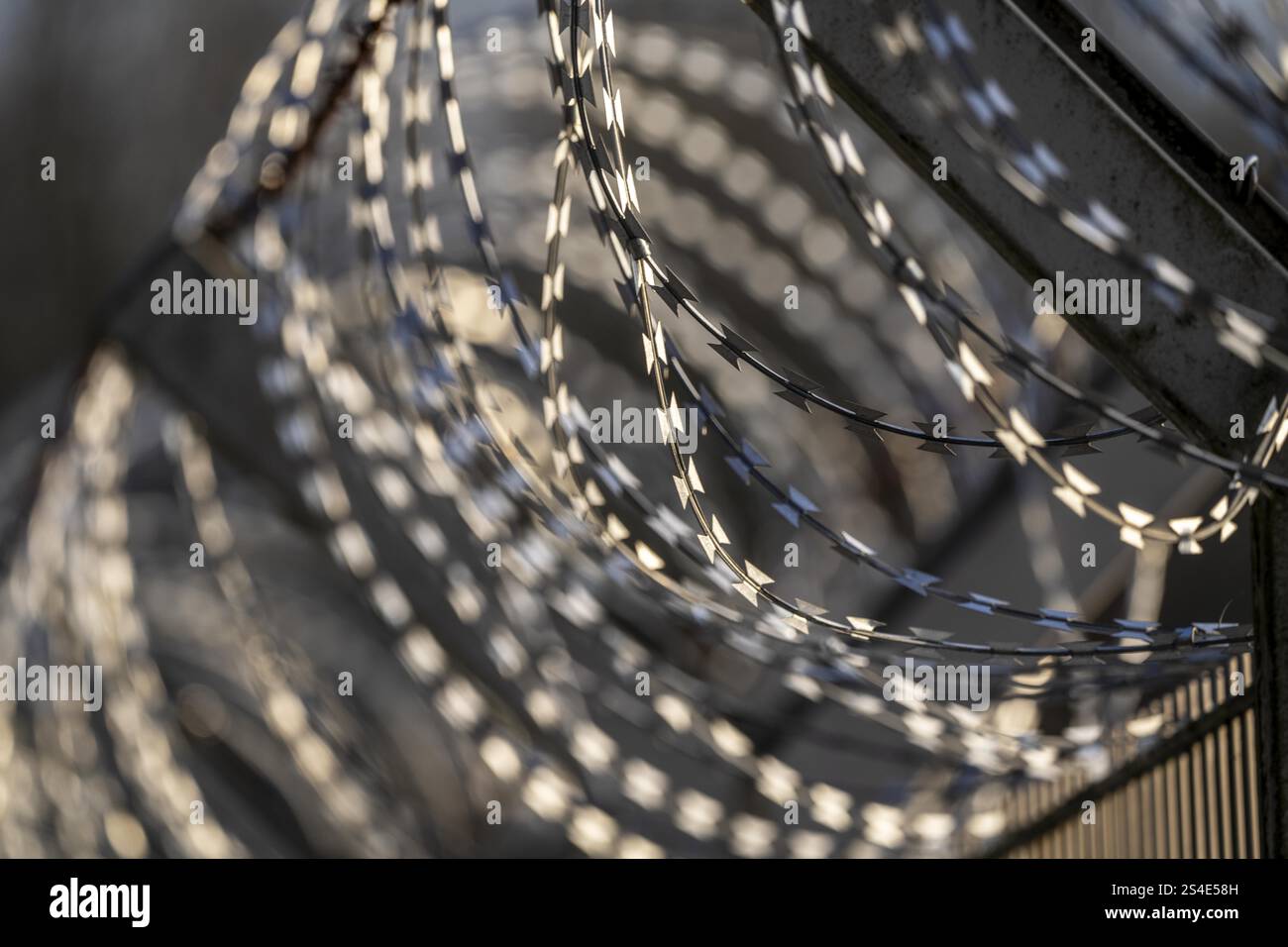 Symbolic image security, S-wire rolls, NATO wire, on a fence top ...