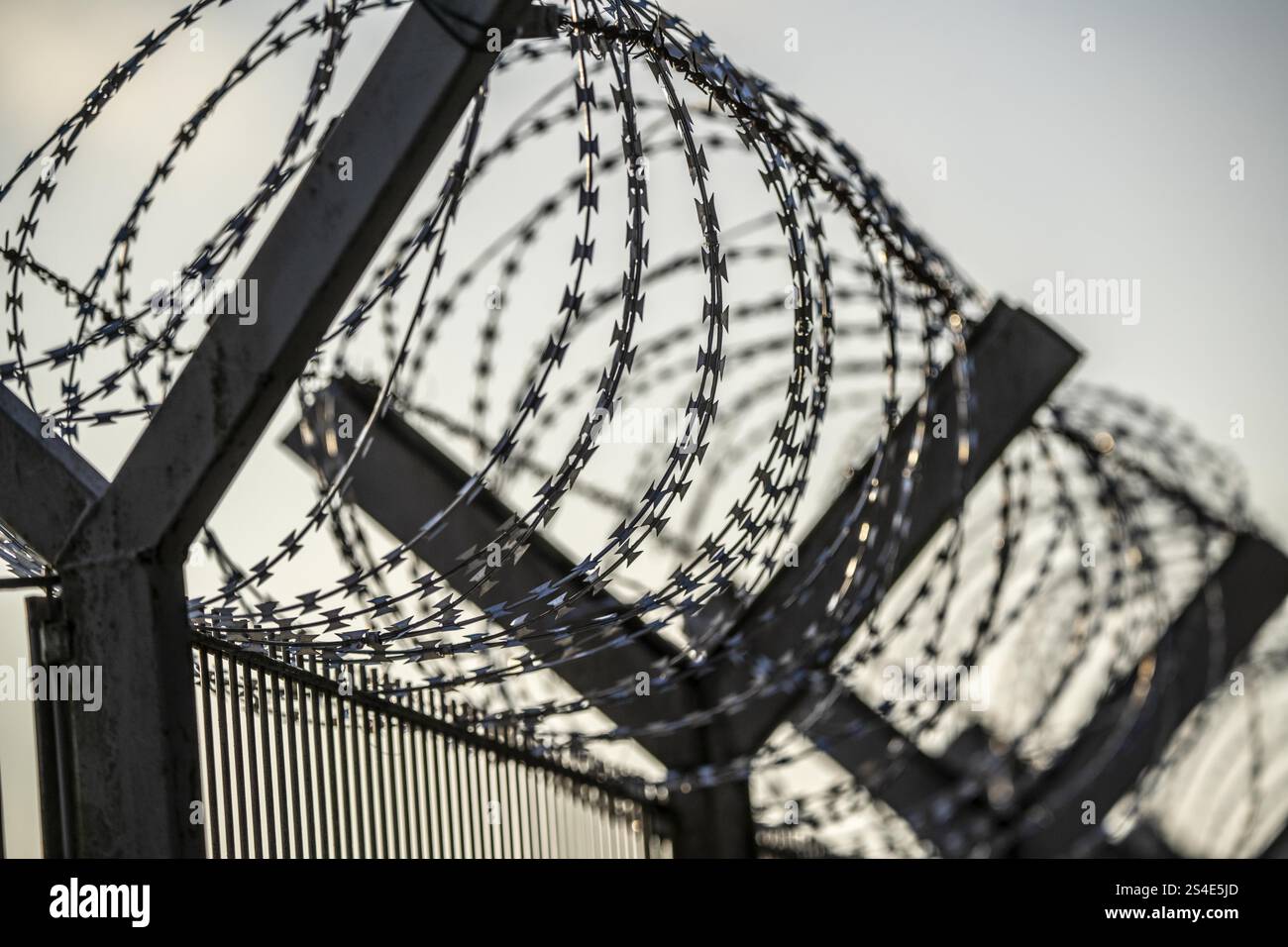 Symbolic image security, S-wire rolls, NATO wire, on a fence top ...