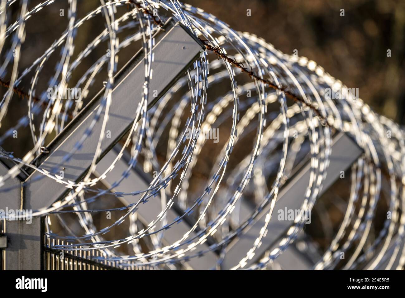 Symbolic image security, S-wire rolls, NATO wire, on a fence top ...