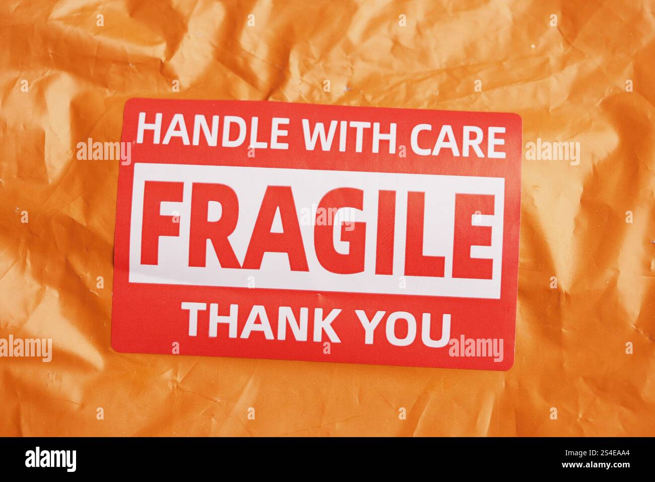 A cardboard box marked with a caution label for fragile goods handling during shipping Stock ...