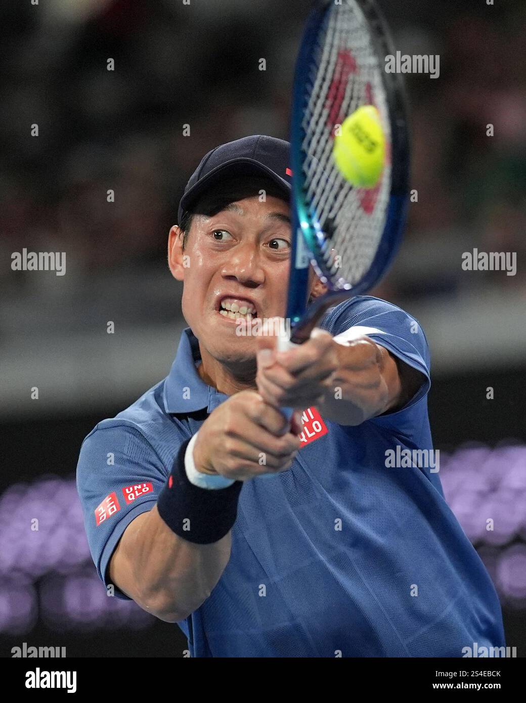 Kei Nishikori of Japan plays a backhand return to Thiago Monteiro of ...