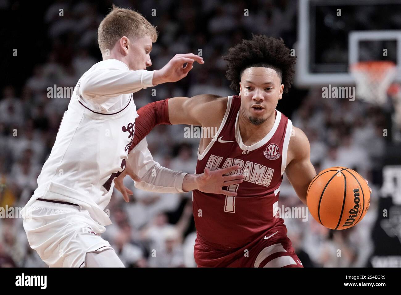 Alabama guard Mark Sears (1) drives around Texas A&M guard Hayden ...