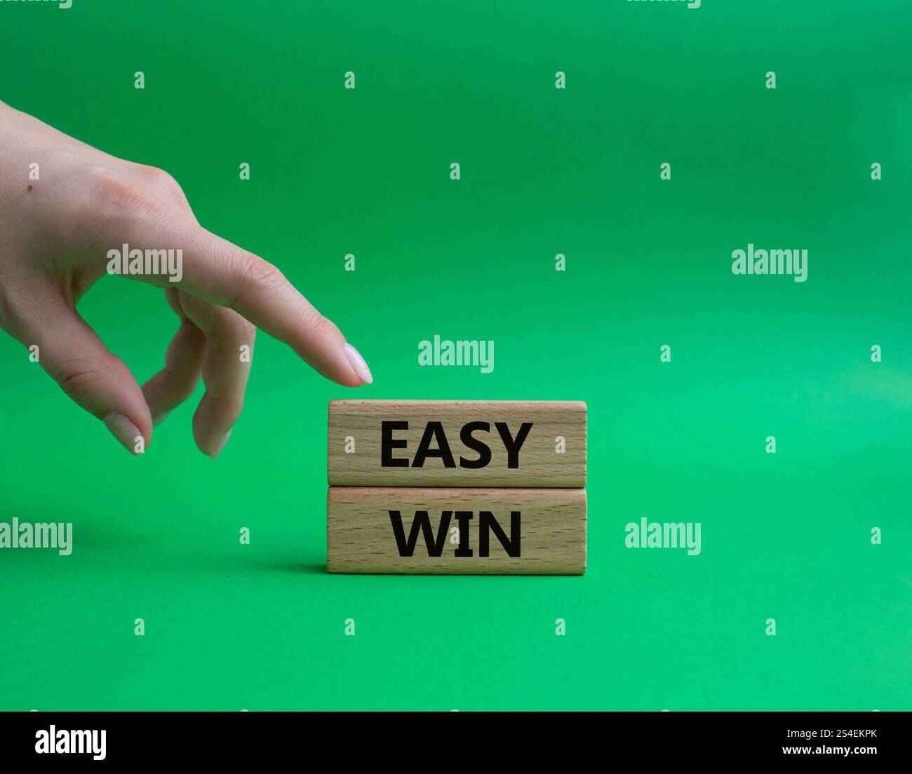 Easy win symbol. Wooden blocks with words Easy win. Beautiful green ...