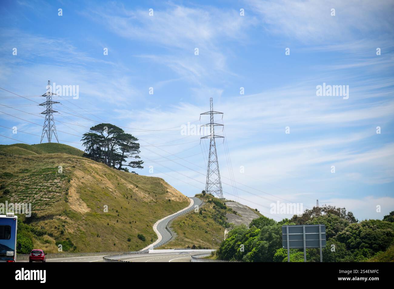Power pylons along Transmission Gully Motorway. Cars travelling on the ...