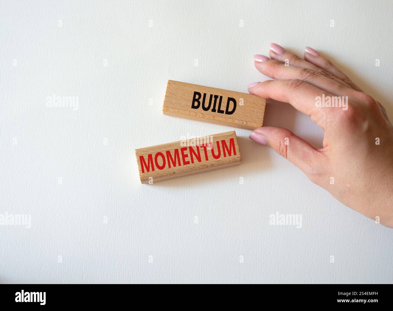 Build momentum symbol. Wooden blocks with words Build momentum ...