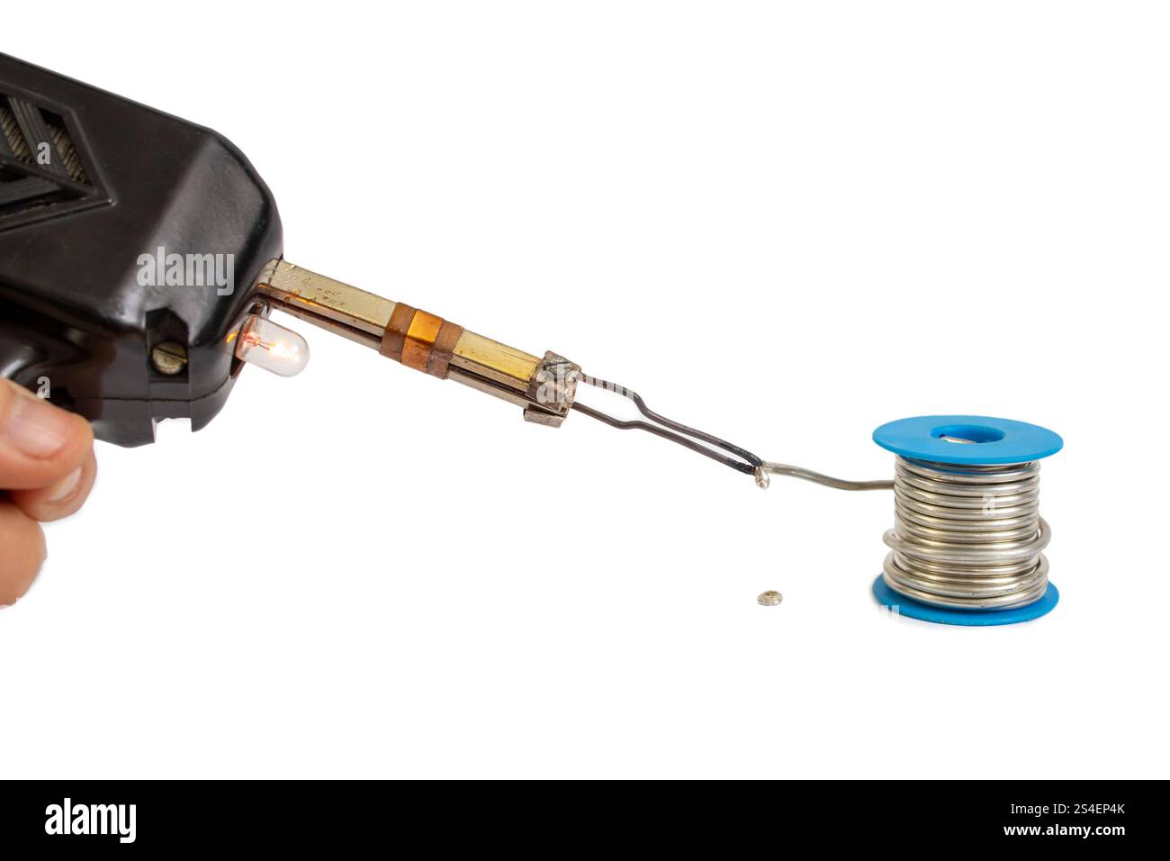 Vintage soldering gun melting coiled wire on white background, soft ...