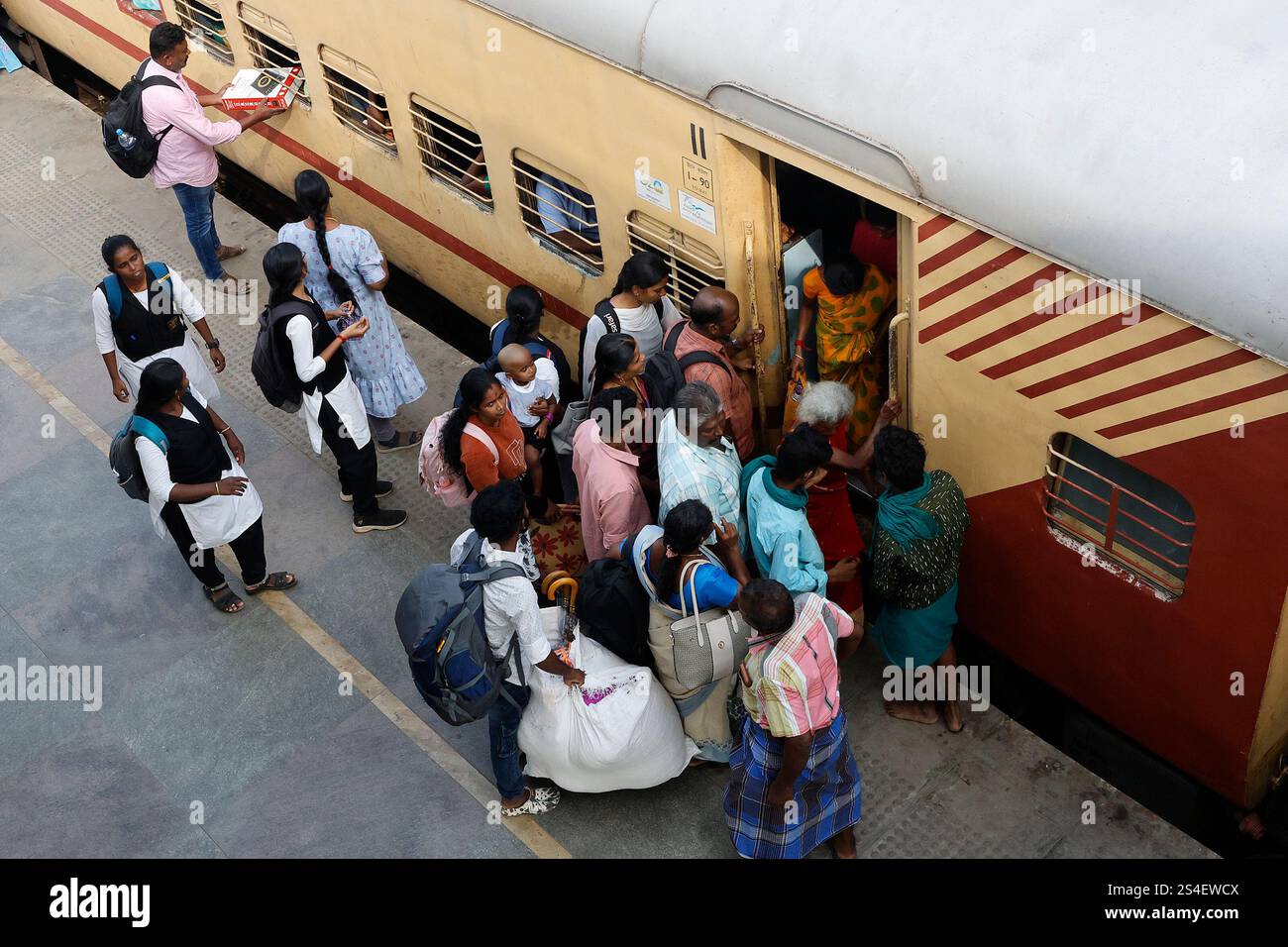 Passengers boarding a train at the railway station in Madurai, Tamil ...