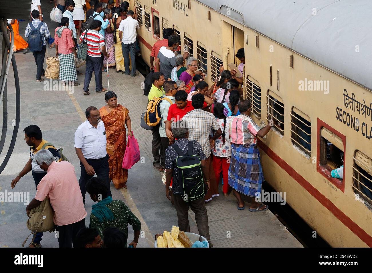 Passengers boarding a train at the railway station in Madurai, Tamil ...