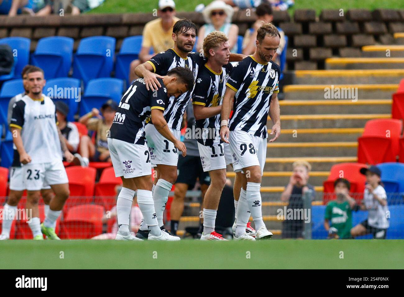 Jed Drew of Macarthur FC (3rd left) celebrates with teammates after ...