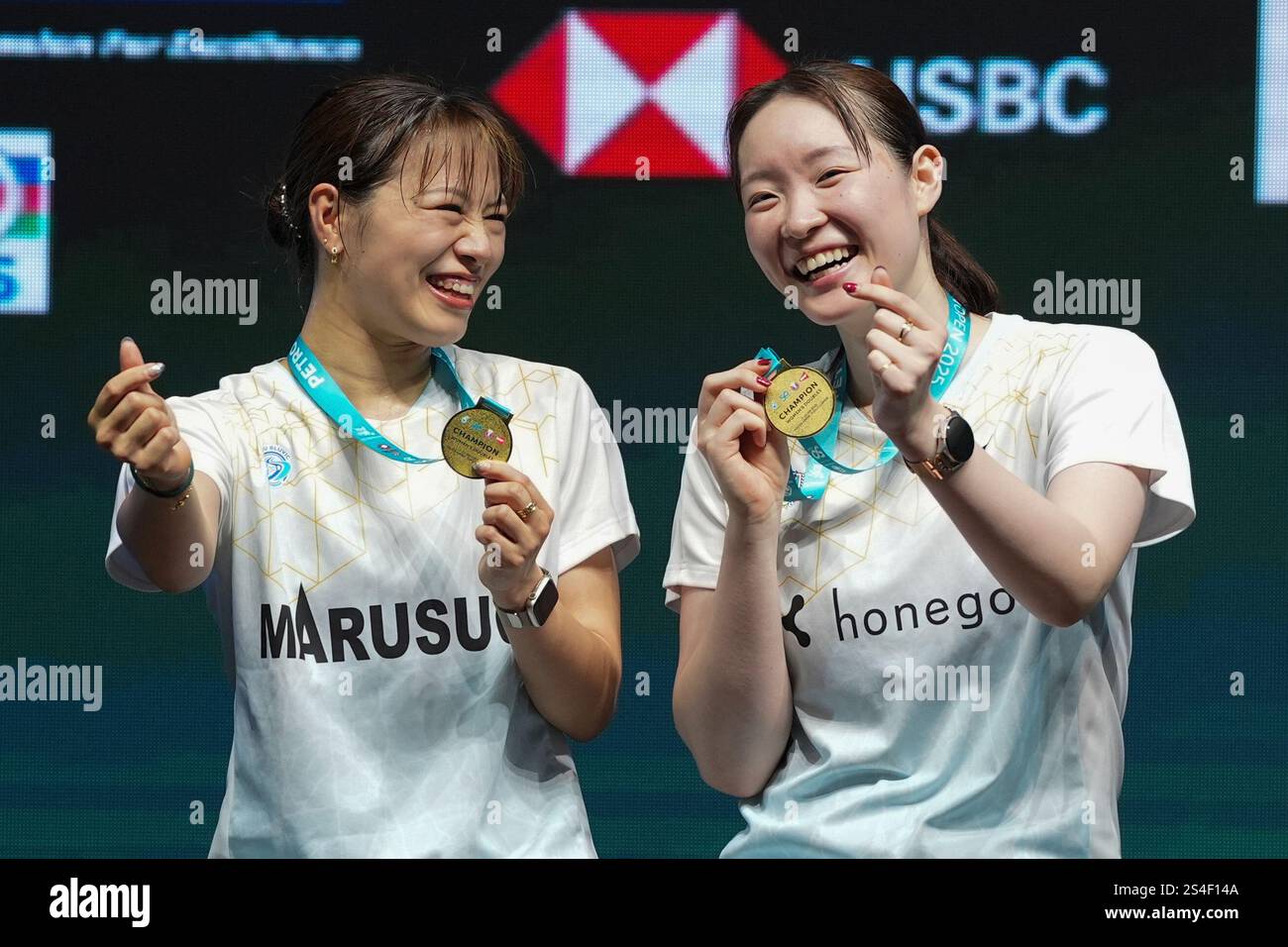 Second placed Japan's Yuki Fukushima, left and Mayu Matsumoto pose with ...