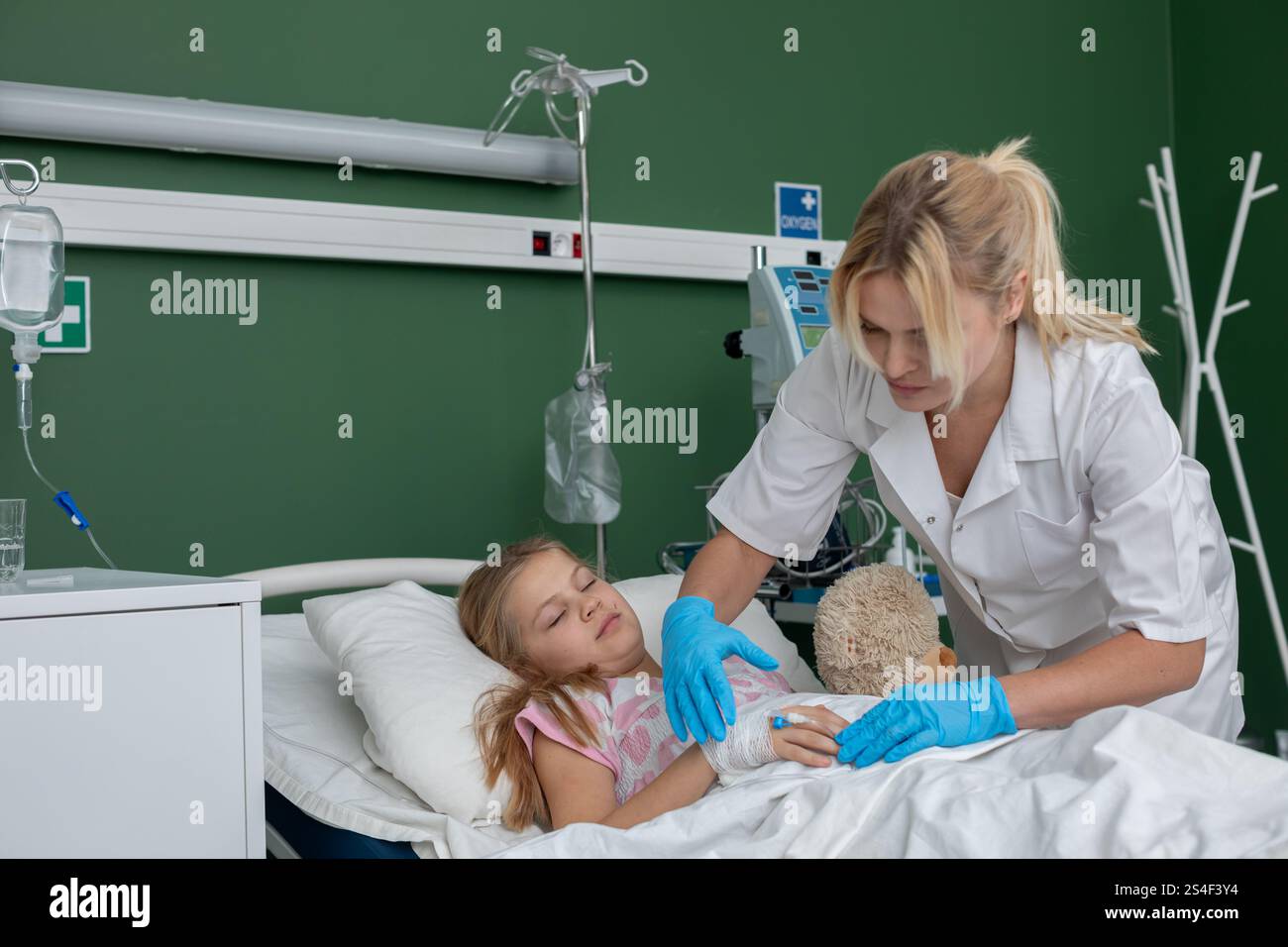 A nurse showing compassion and care for a young child patient lying in ...