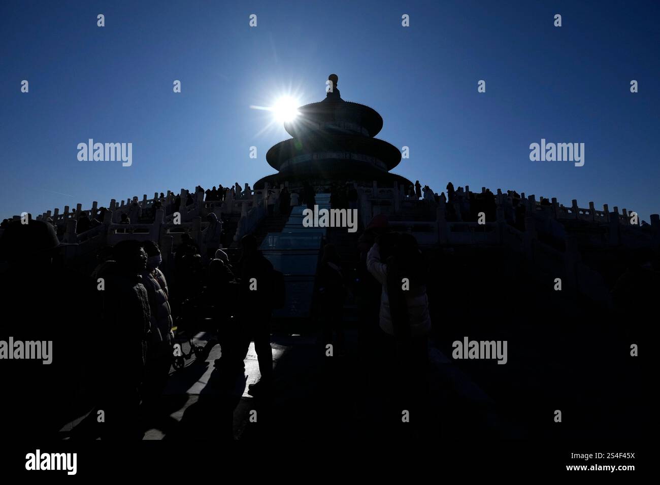 The sun rises at the Temple of Heaven complex as tourists flock on ...
