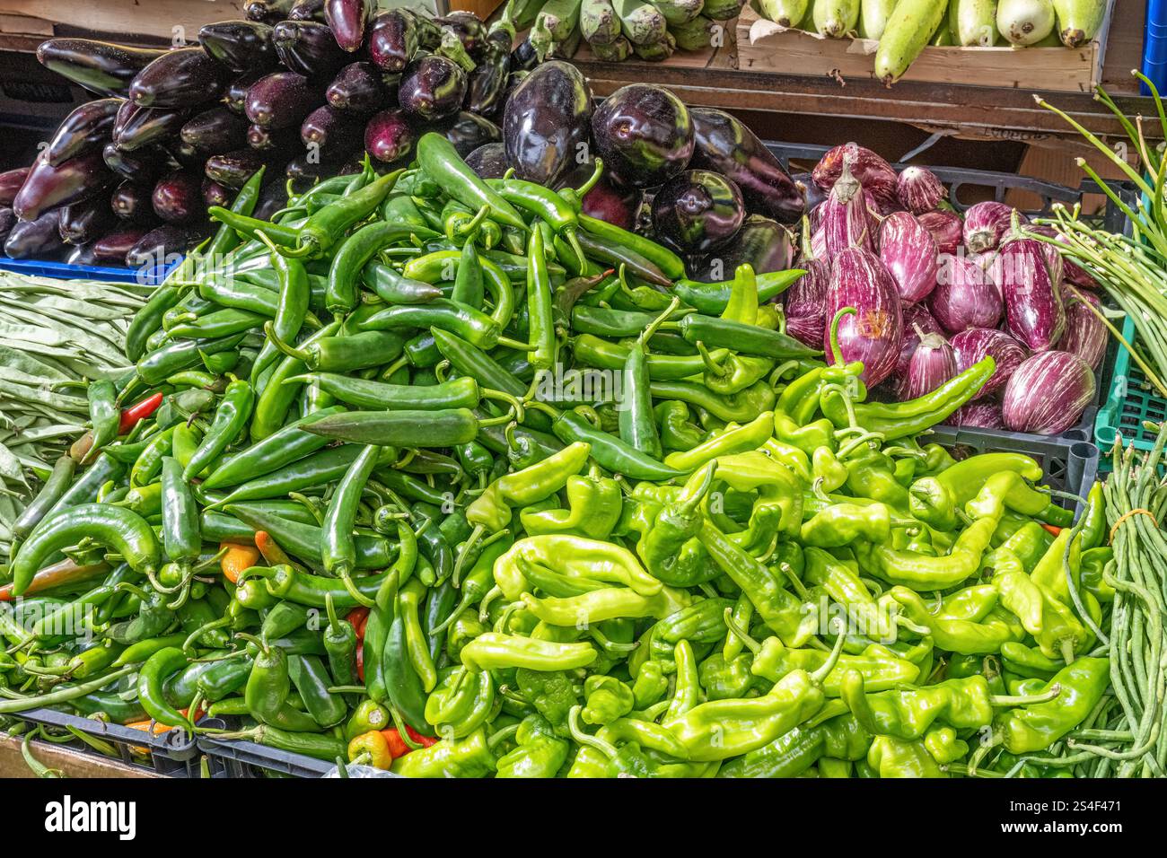 Eggplant and chilli peppers for sale at a market Stock Photo - Alamy
