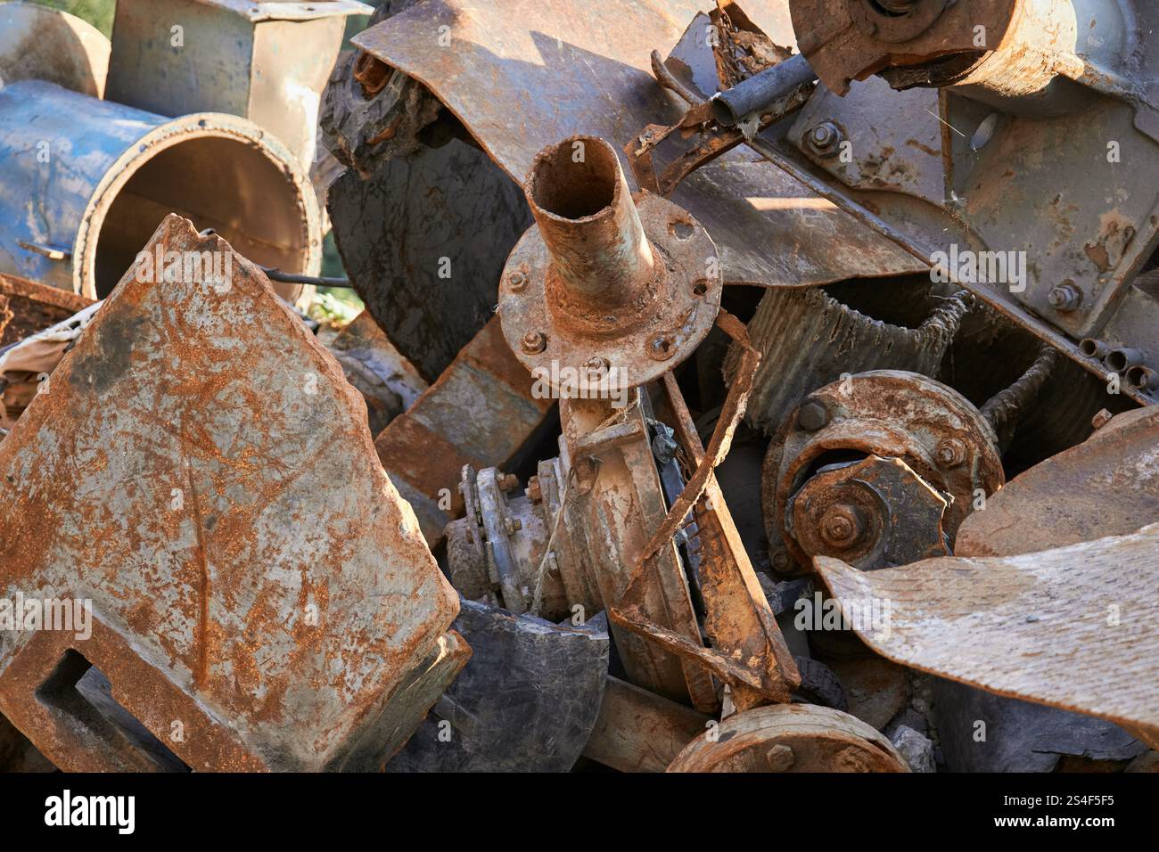 A large and rusty industrial scrap metal pile stacked high with ...