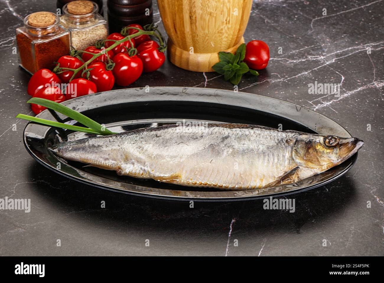 Whole raw salted herring fish in the plate Stock Photo - Alamy