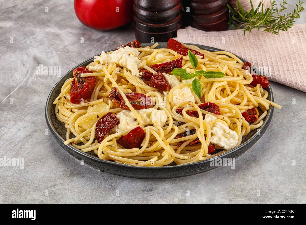 Italian pasta spaghetti with stracciatella and tomato Stock Photo - Alamy