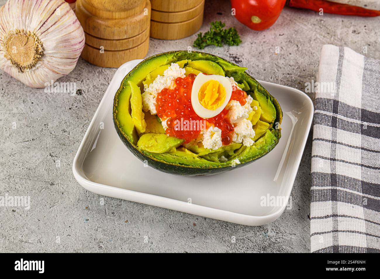 Avocado with red caviar and quil egg and soft cheese Stock Photo - Alamy