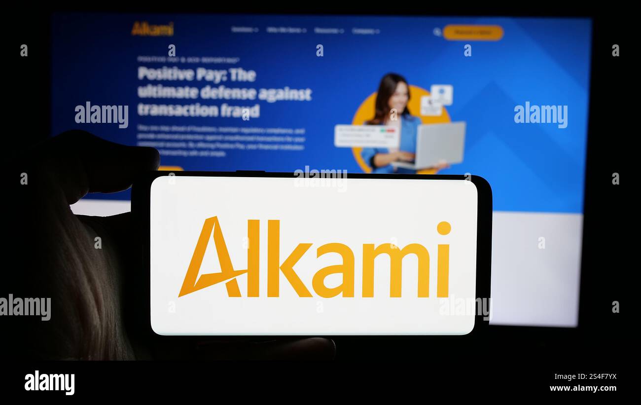 Germany. 11th Oct, 2024. In this photo illustration, a person is holding a cellphone with the ...