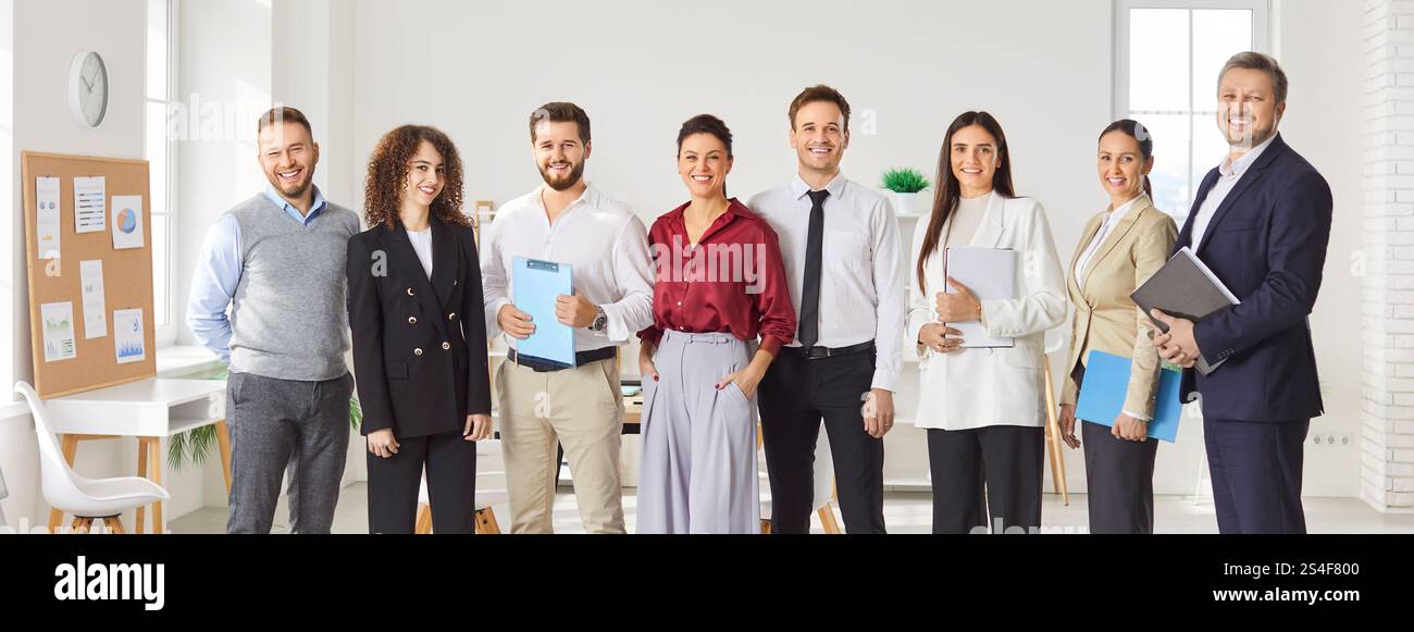 Confident smiling business people standing together in office, showing ...