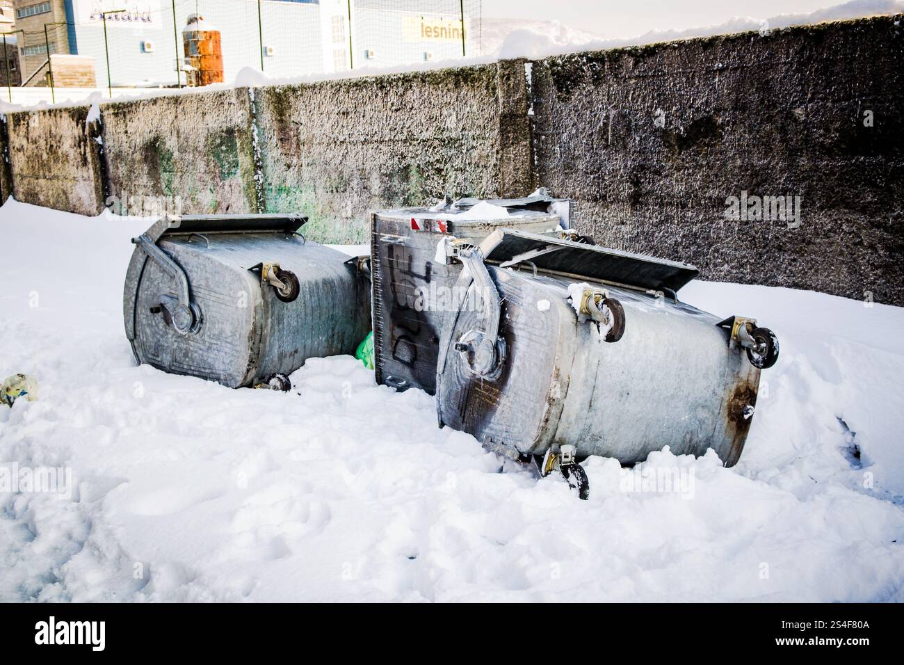 Overturned garbage containers during strong and snowy winter Stock ...