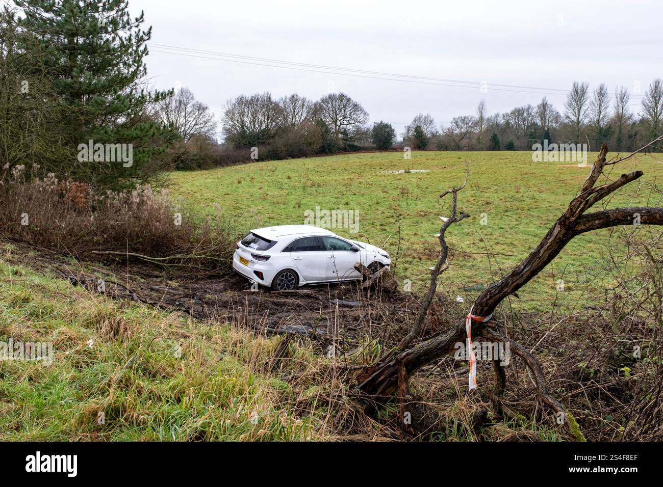 Car crashed into farm field by missing T-junction Stock Photo - Alamy