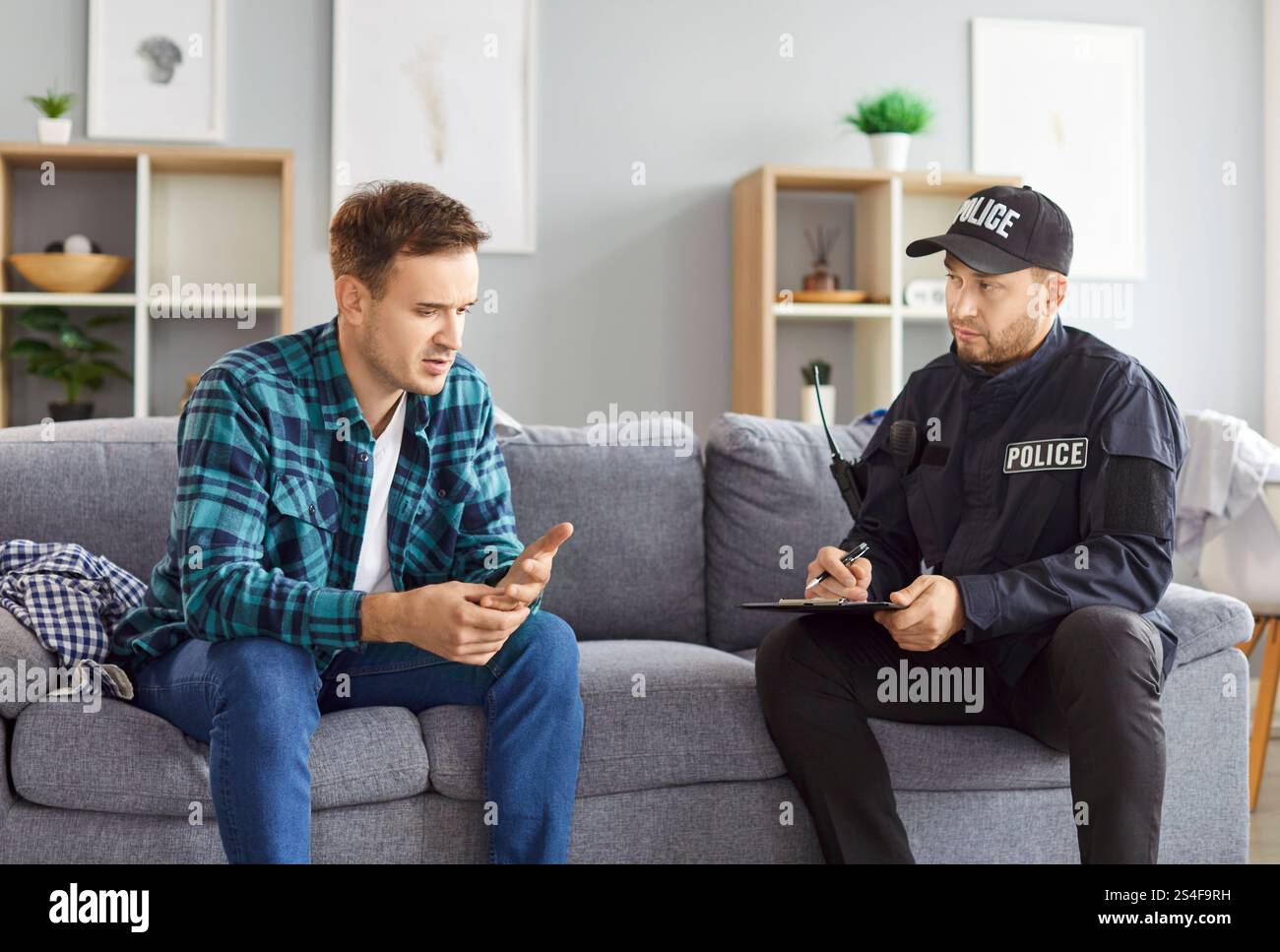 Male Crime Victim Giving Statement To Police Officer At Home Stock ...