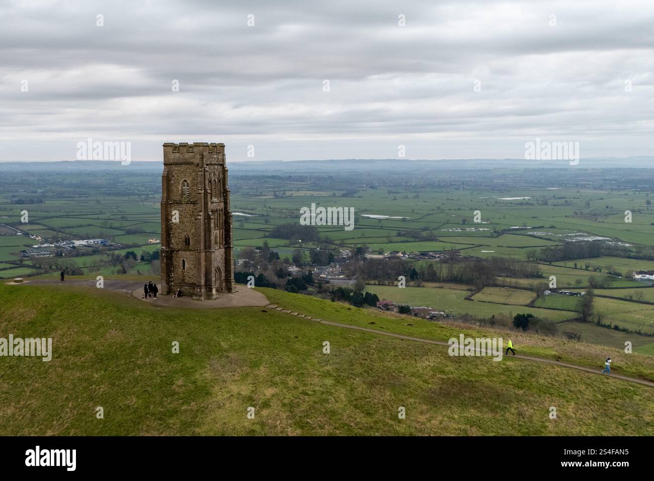 People walk around Glastonbury Tor for an early morning view of the ...