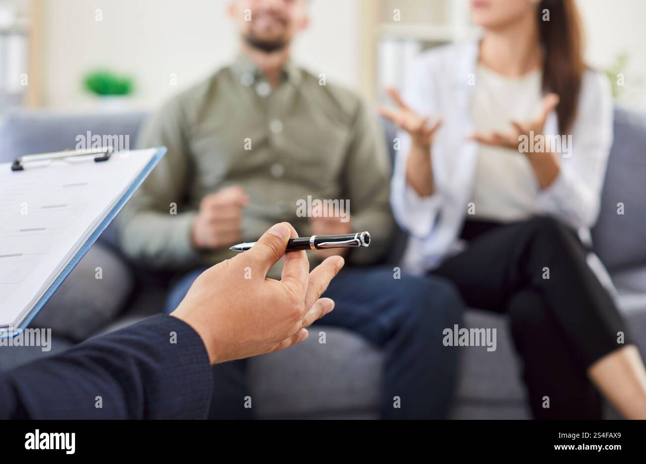 Psychologist Conducting Therapy Session For Family Couple Stock Photo ...