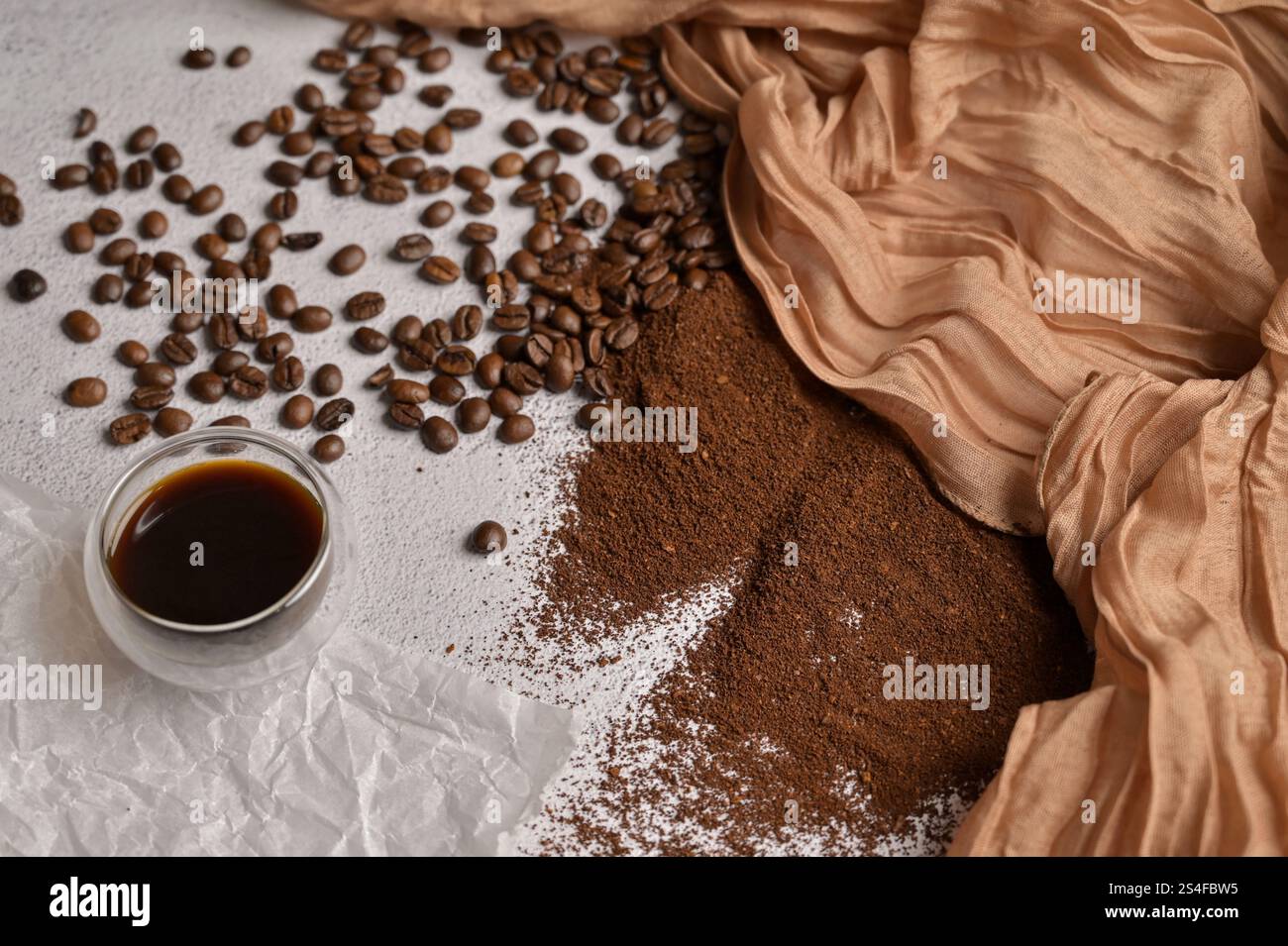 Fresh aromatic grain, ground and coffee drink, white background, brown ...
