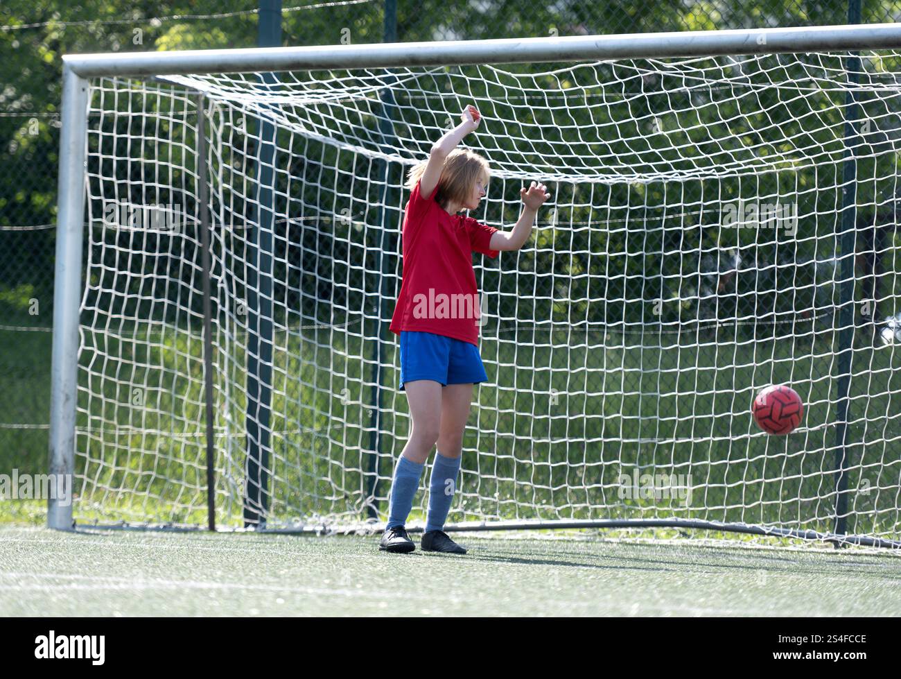Girl Goalkeeper Stands At Goalposts During Children'S Football Match ...
