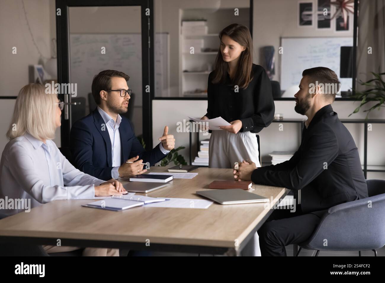 Four business partners discussing project hi-res stock photography and ...