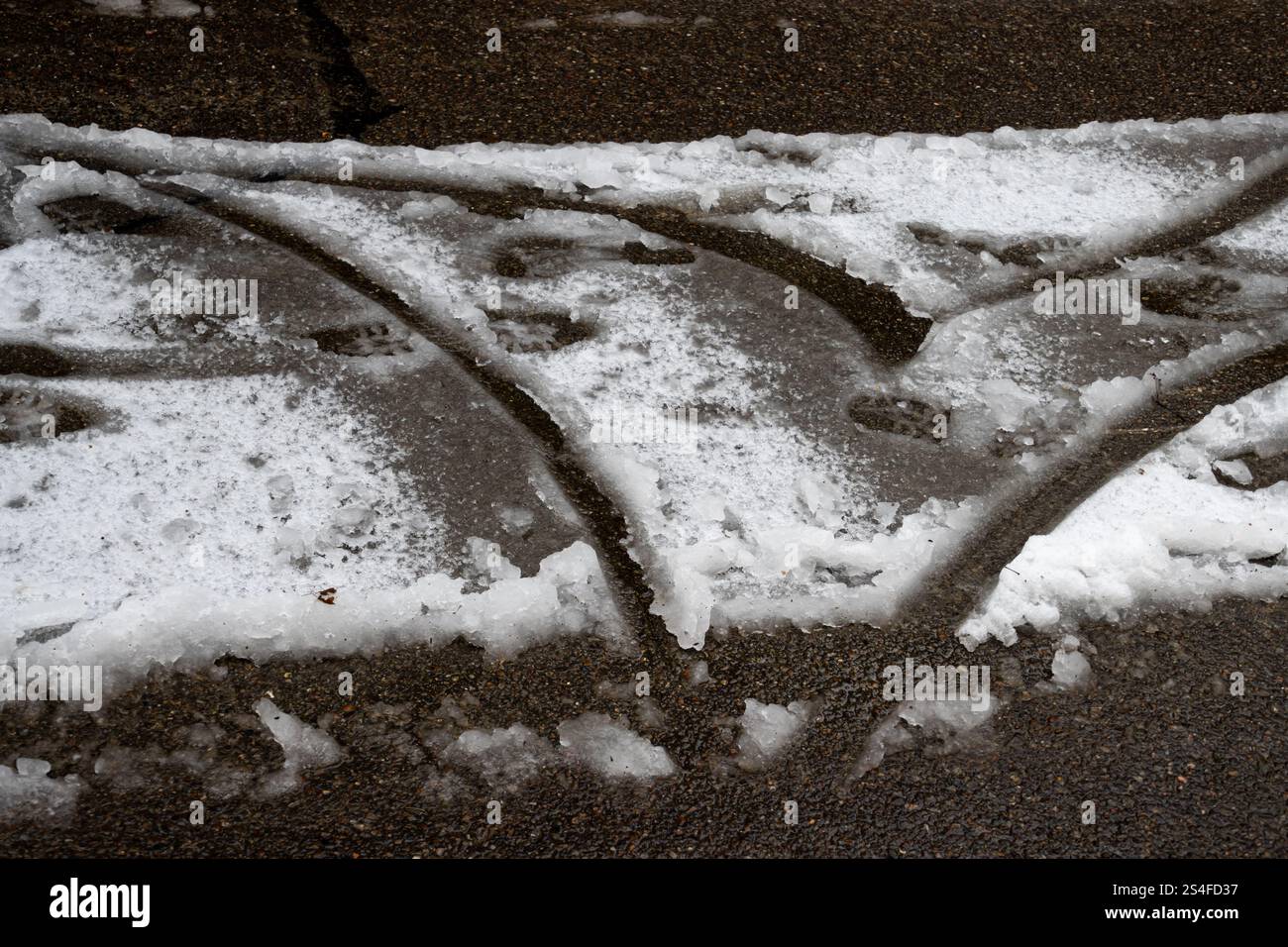 An image showing tire tracks and footprints embedded in melting snow on ...