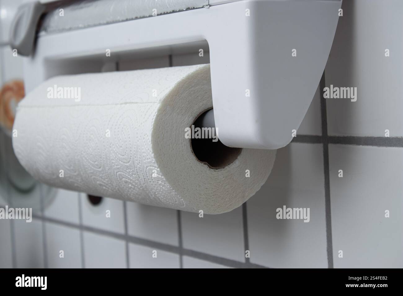 A kitchen paper towel roll hanging on the wall in the kitchen Stock ...