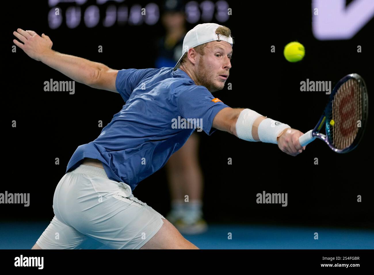 Gauthier Onclin of Belgium plays a backhand return to Reilly Opelka of ...