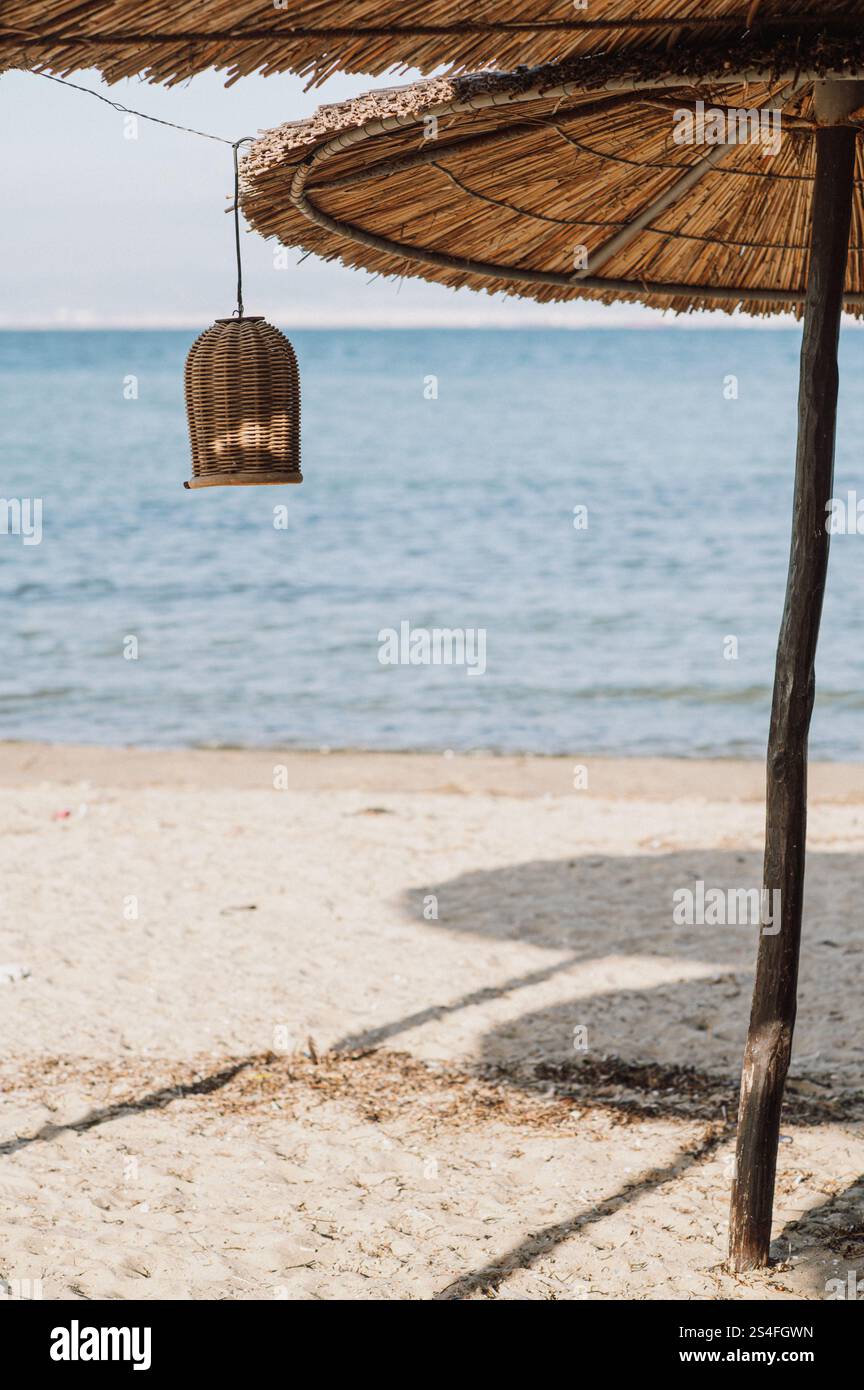 shade on the beach with straw umbrellas cups and rustic decor Stock ...