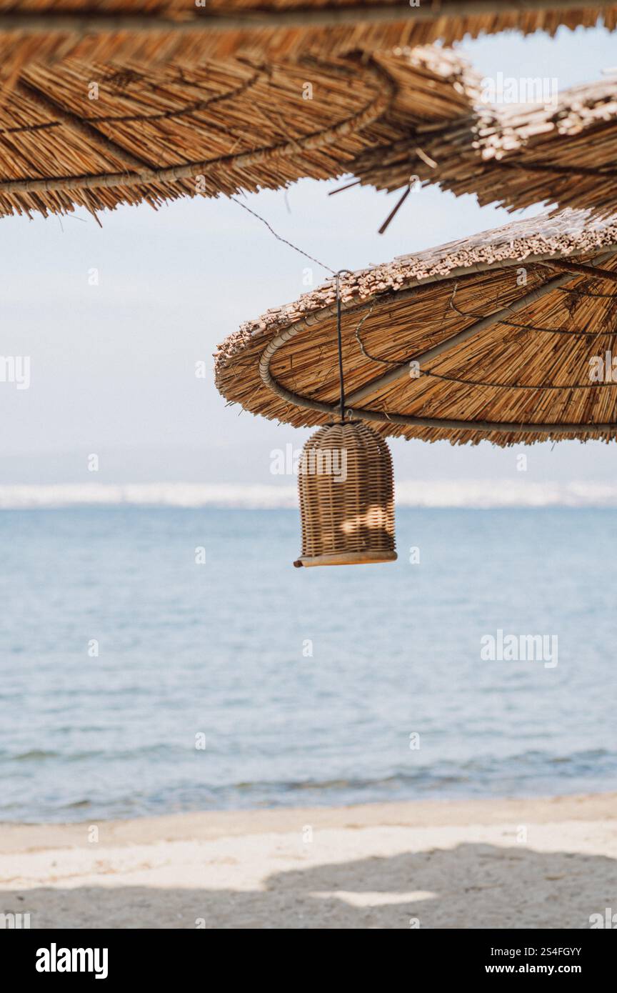 shade on the beach with straw umbrellas cups and rustic decor Stock ...
