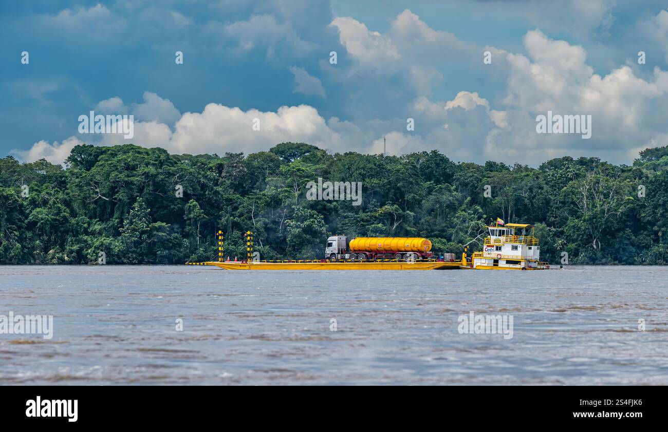 Transport boat on Napo River carrying oil tanker, for the oil industry ...