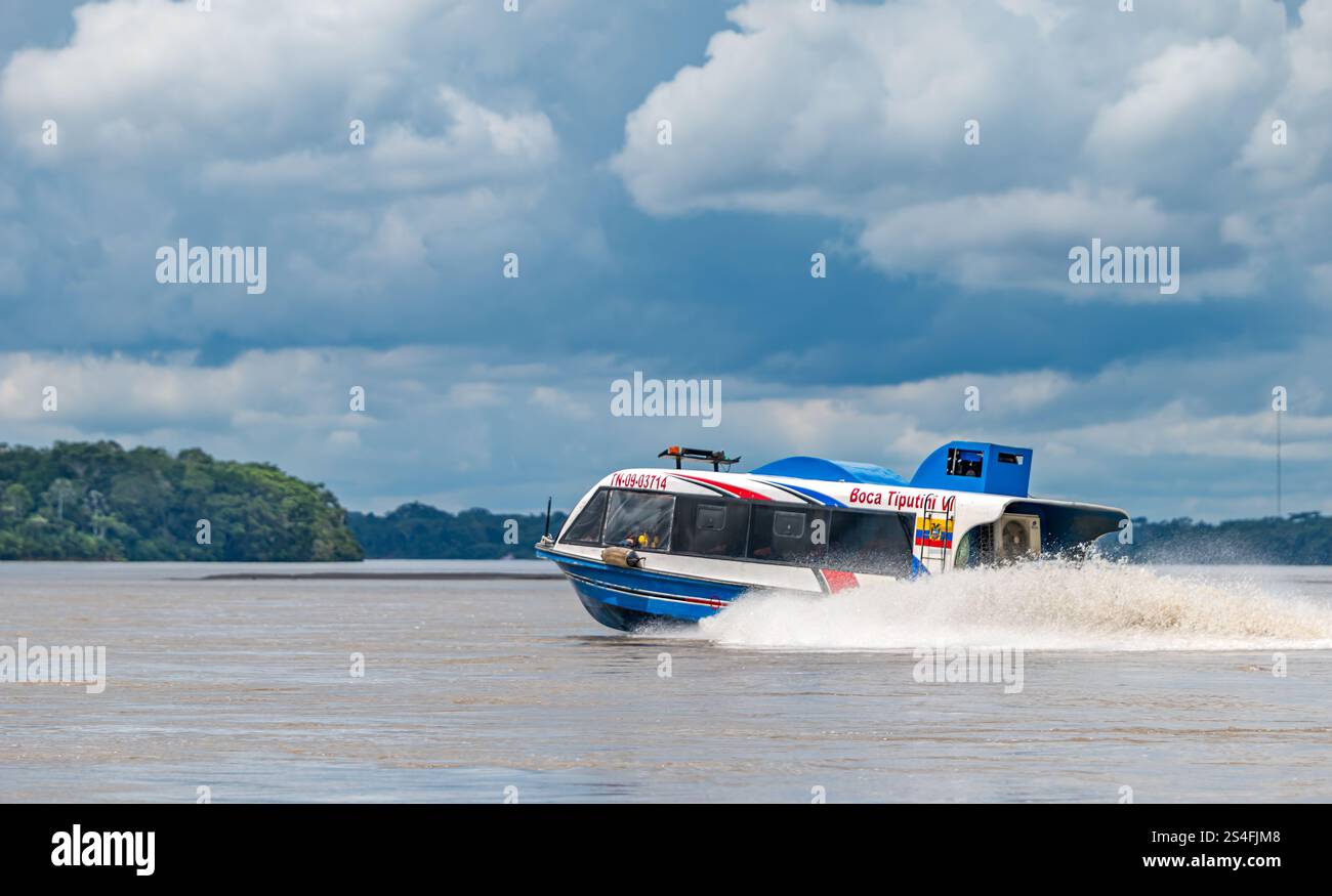 Transport boat speeding on Napo River in the Amazon rainforest, Ecuador ...