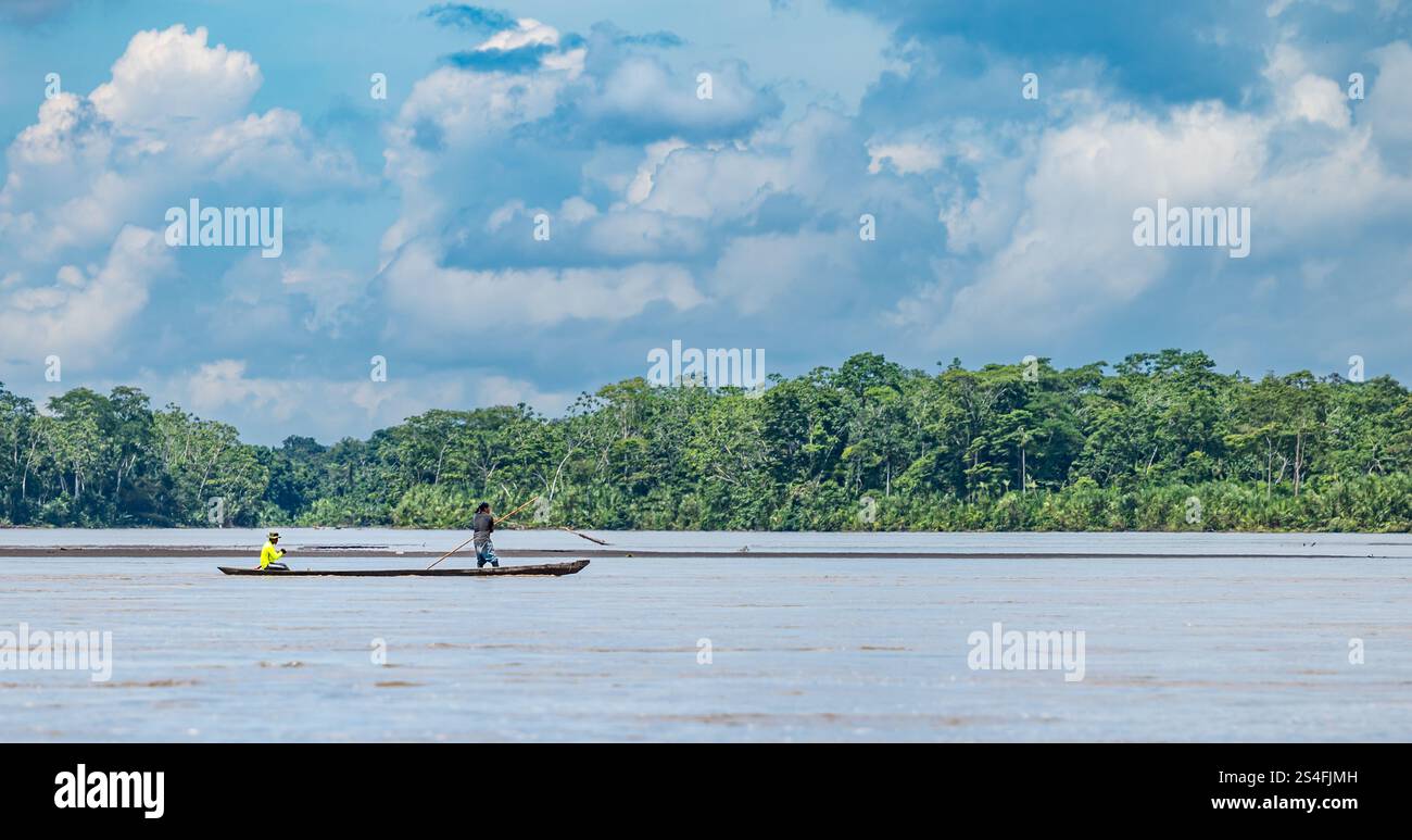 Local people in canoe longboat in Napo River in the Amazon rainforest ...