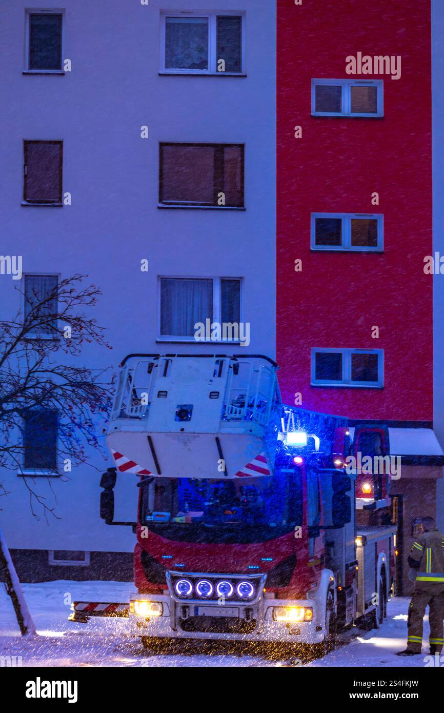 Winter rescue operation in an apartment building, fire truck with a ...