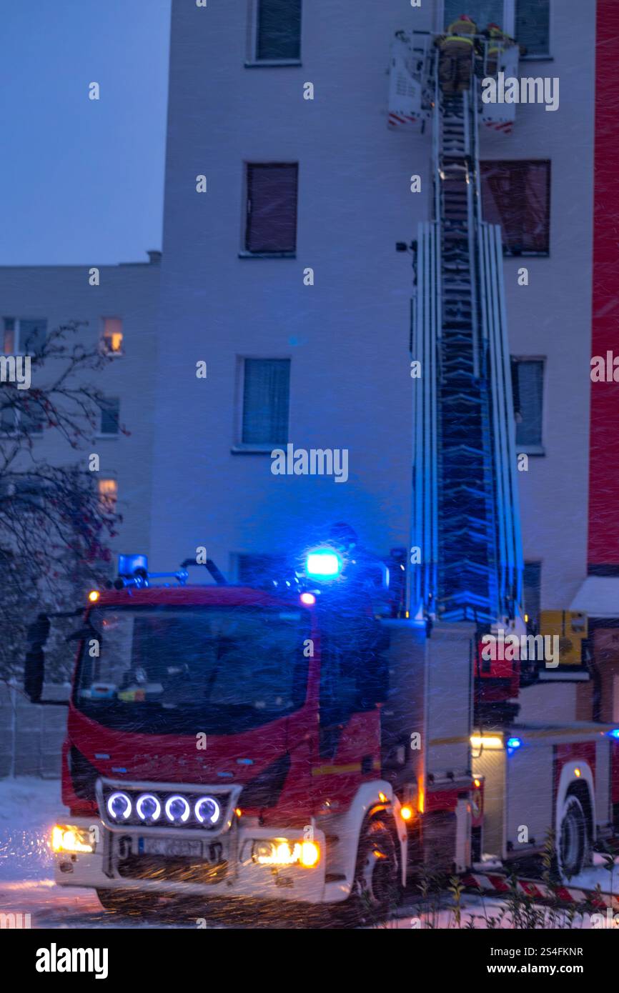 Winter rescue operation in an apartment building, fire truck with a ...