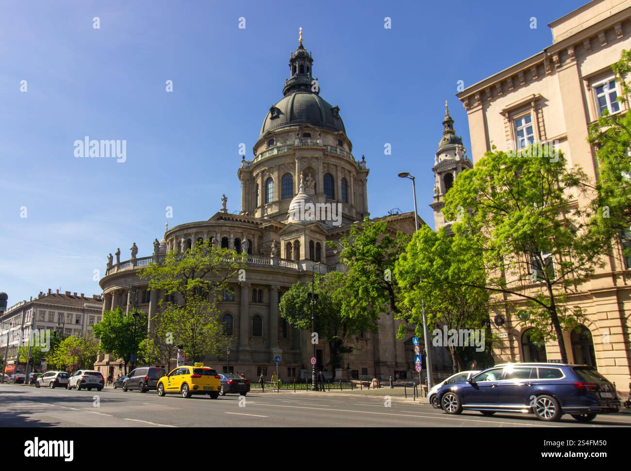 St. Stephen's Basilica surrounded by trees and busy streets in Budapest ...